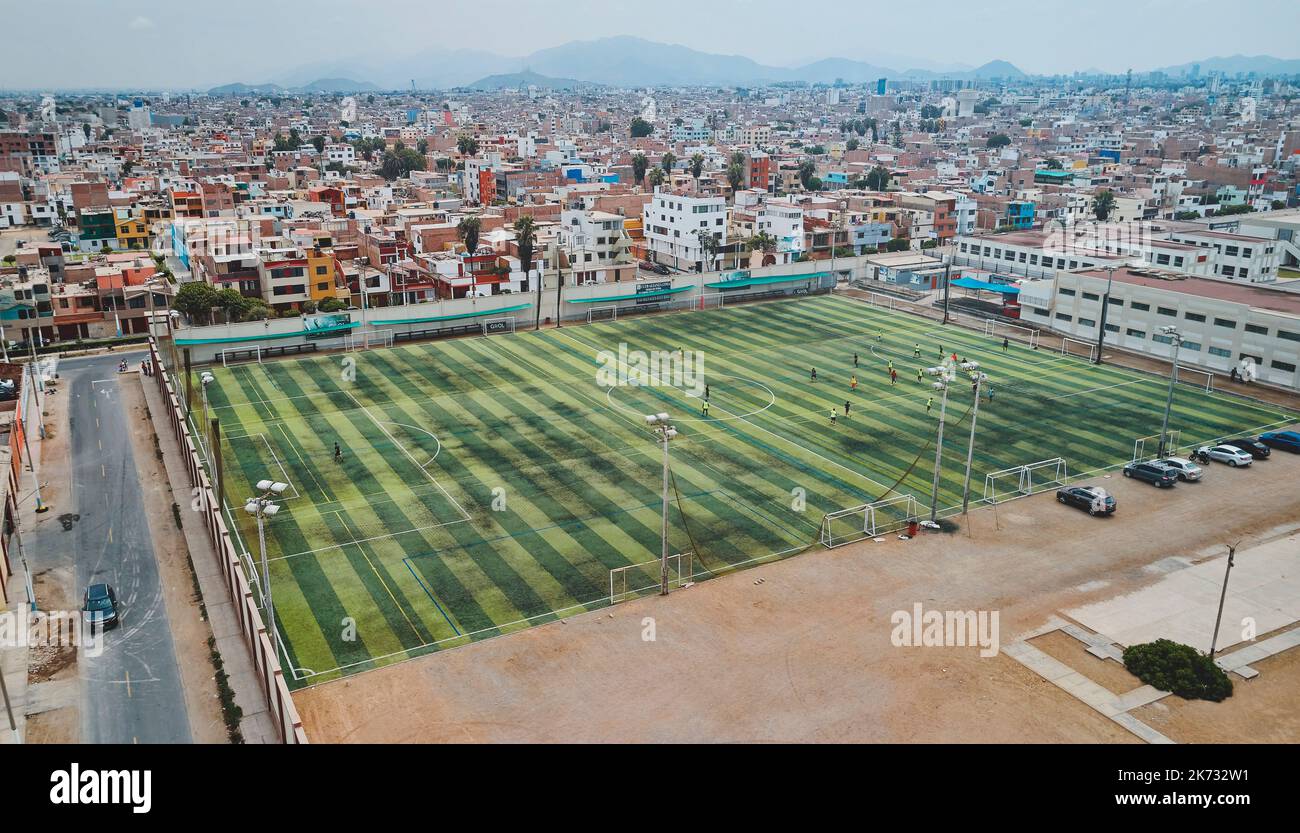 Aerial view of the football field in the middle of a messy neighborhood ...
