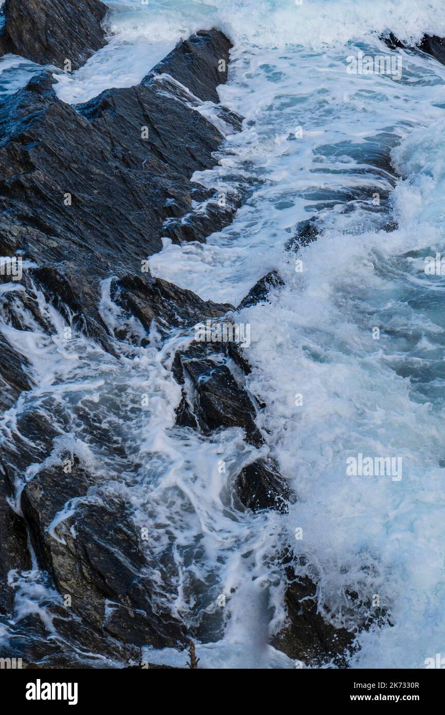 Sea churning around rocks in Cornwall in the UK Stock Photo - Alamy