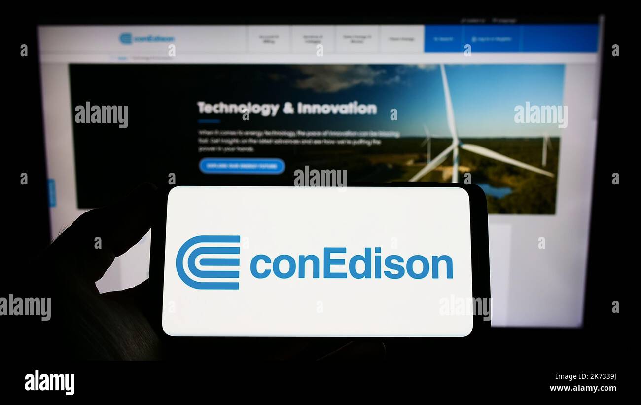Person holding smartphone with logo of US company Consolidated Edison ...