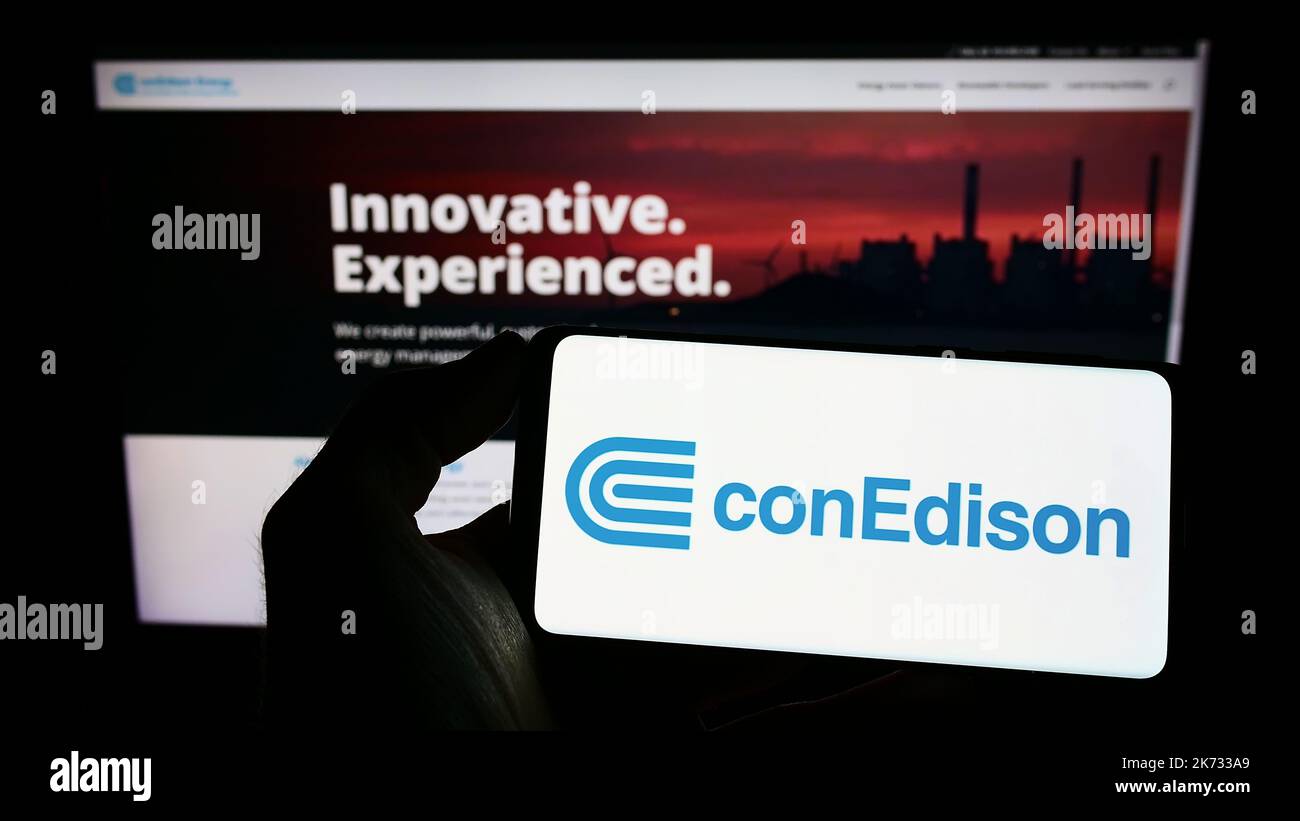 Person holding cellphone with logo of US company Consolidated Edison ...