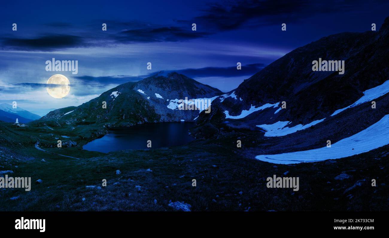 panoramic view of a lake in fagaras mountains at night. summer ...