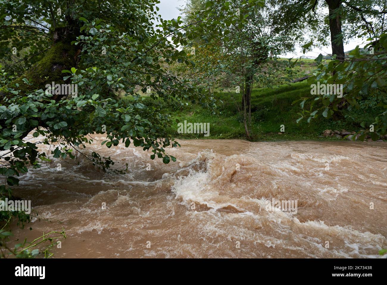 River flooding with muddy waters making rapids and waves Stock Photo ...