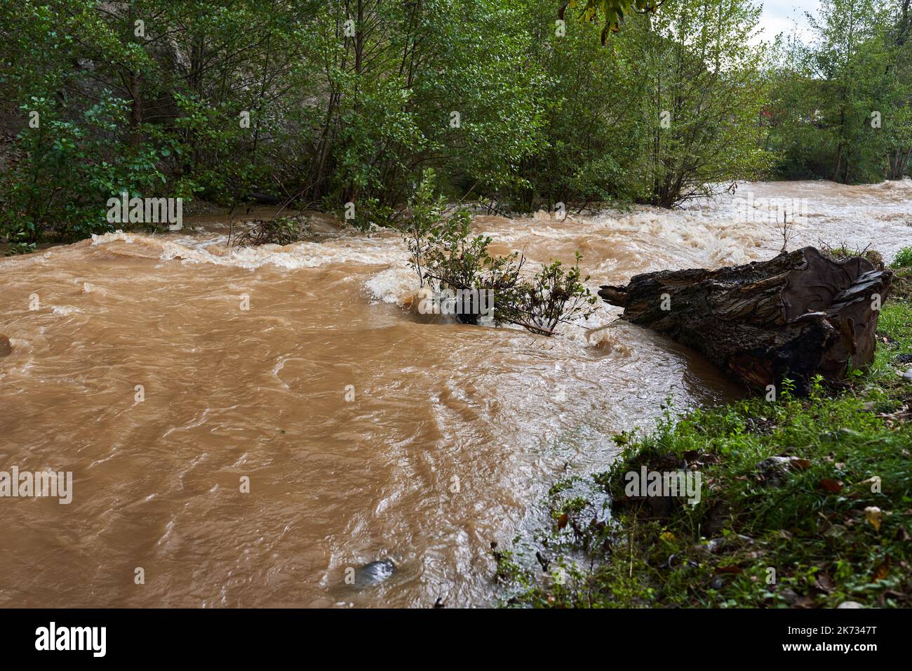 River flooding with muddy waters making rapids and waves Stock Photo ...