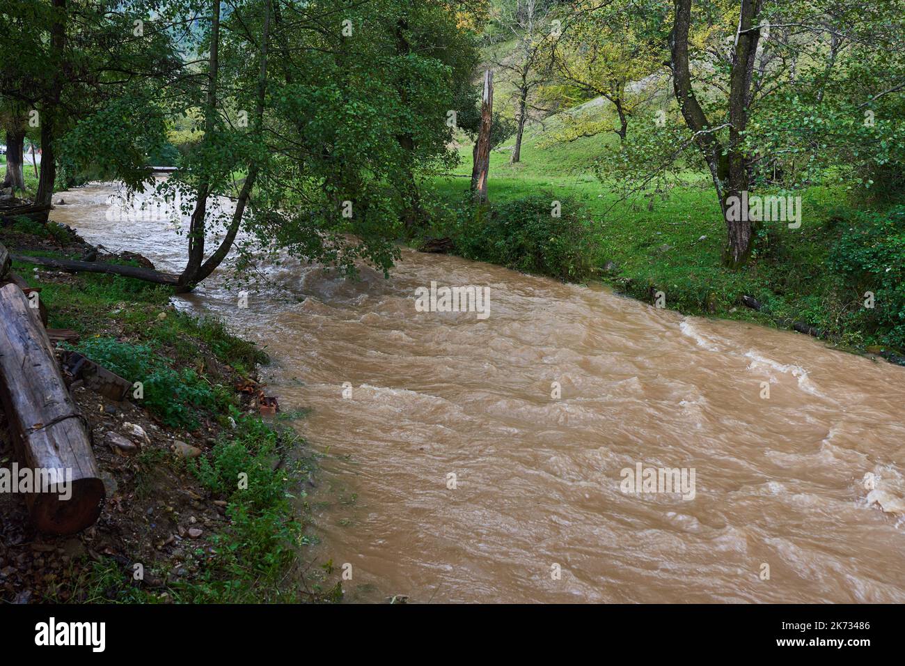 River flooding with muddy waters making rapids and waves Stock Photo ...