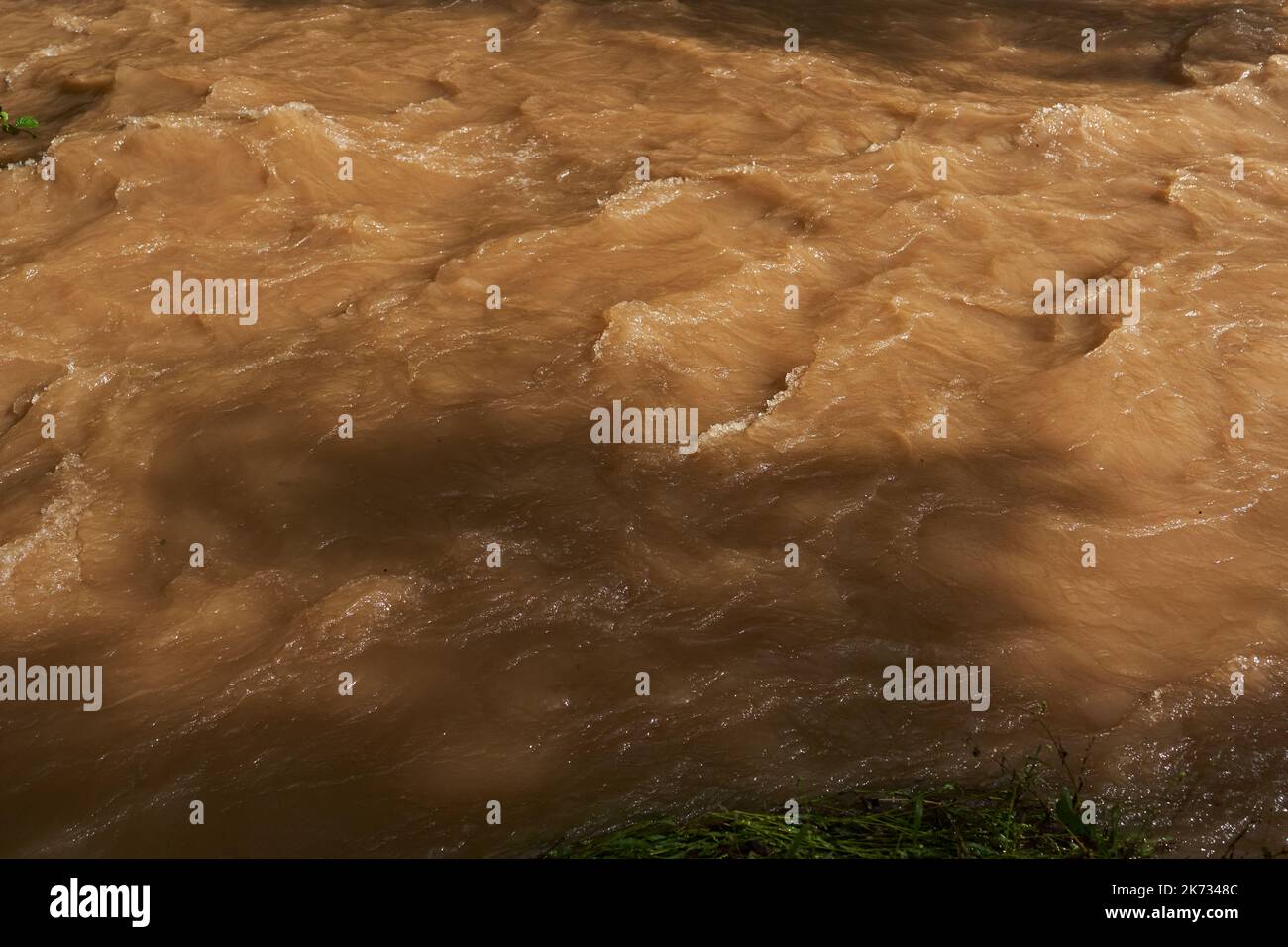River flooding with muddy waters making rapids and waves Stock Photo ...