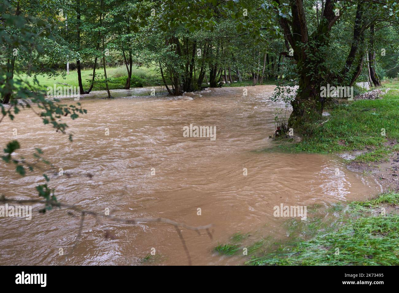 River flooding with muddy waters making rapids and waves Stock Photo ...