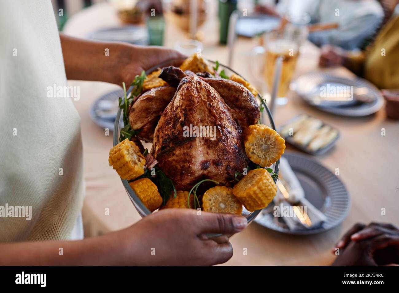 Close up of African American woman bringing homemade chicken dish to ...