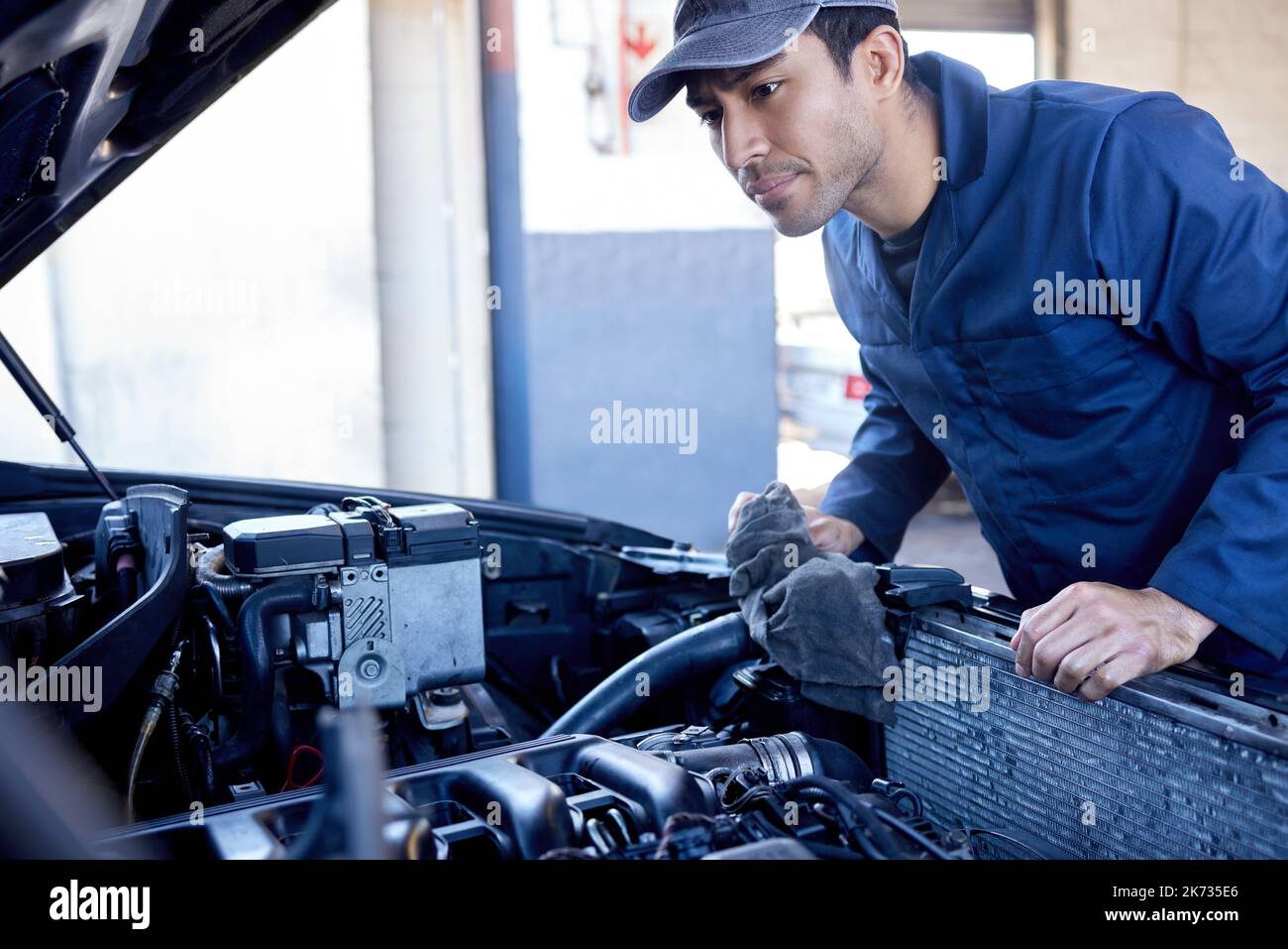 Its important to double-check your work. a handsome young male mechanic ...