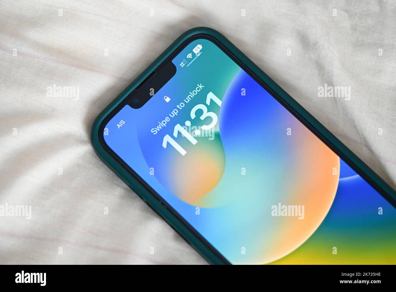 iPhone with iOS 16 logo on home screen, close up new operating system ...