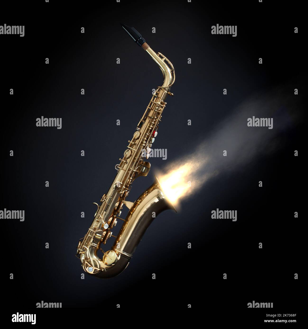 Saxophone on black background with fire and smopke blasting from the ...