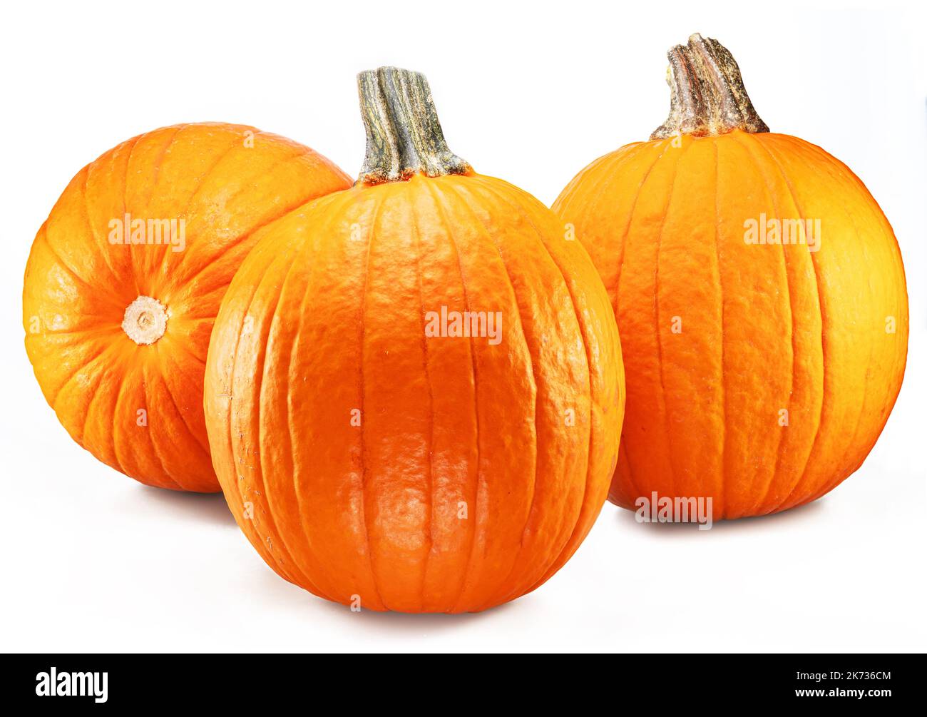 Three orange round pumpkins, symbol of Halloween isolated on white ...