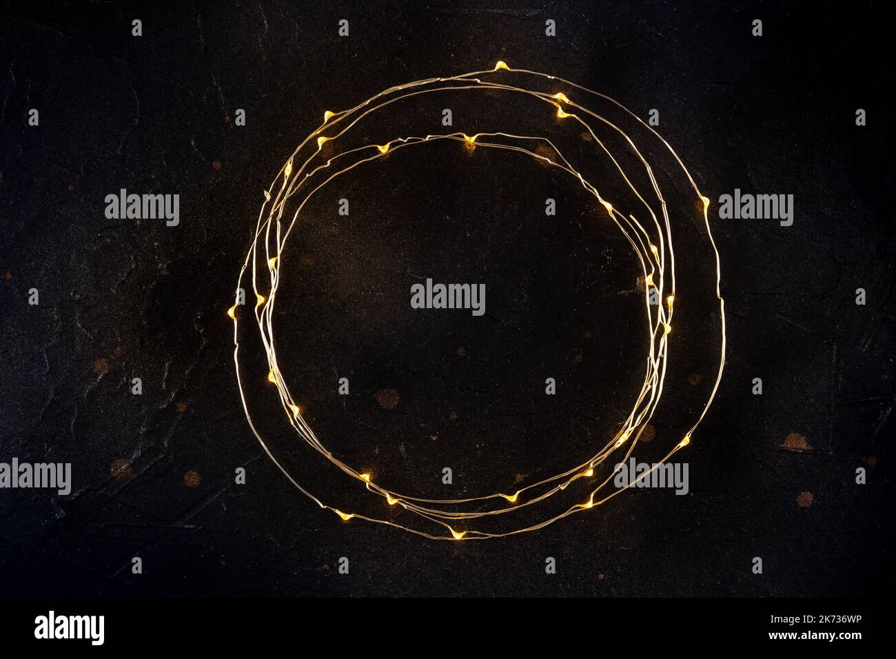 Fairy lights, led garland, overhead flat lay shot on a black background ...