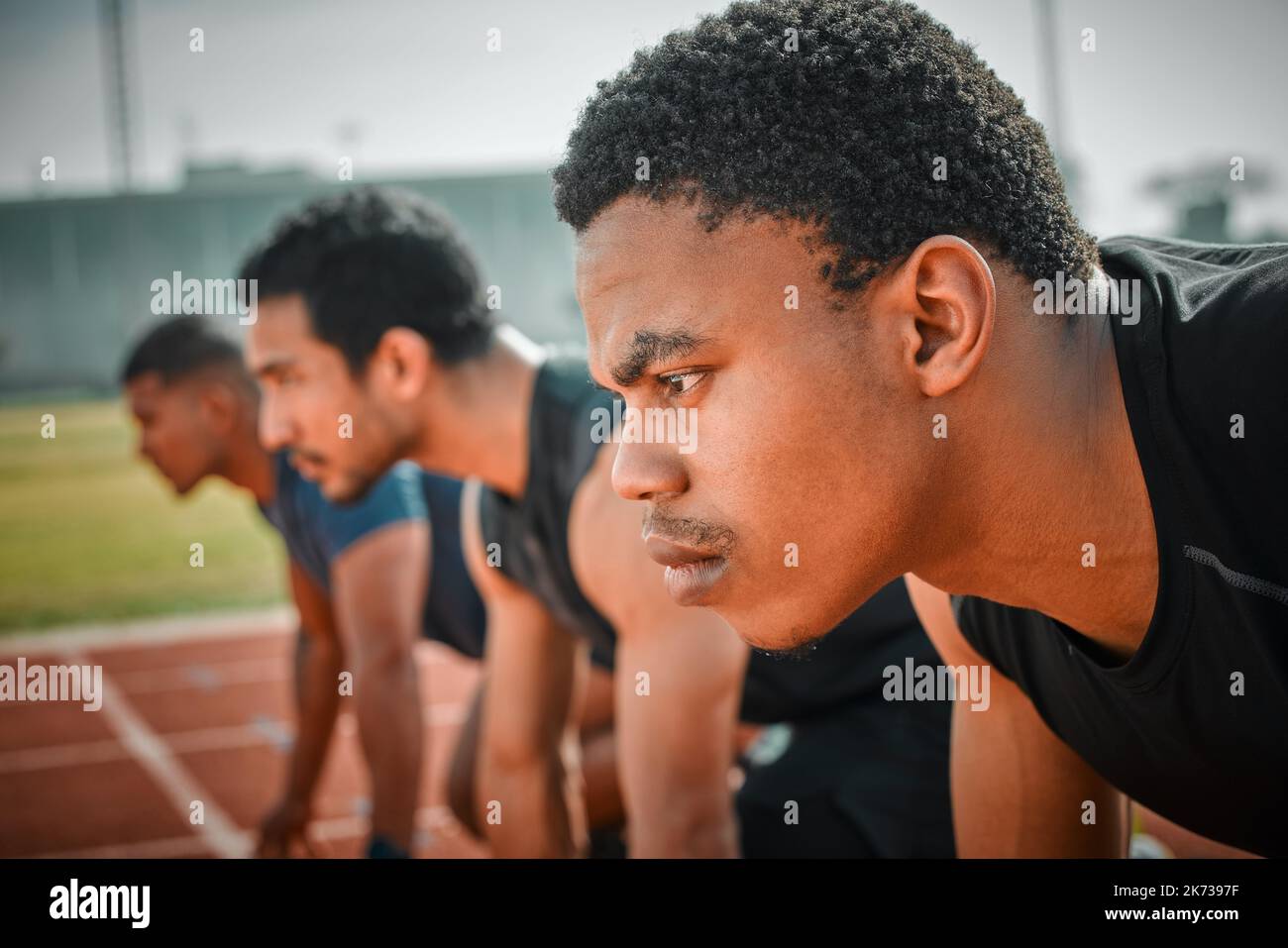 Finishing first is the goal. three handsome young male athletes ...