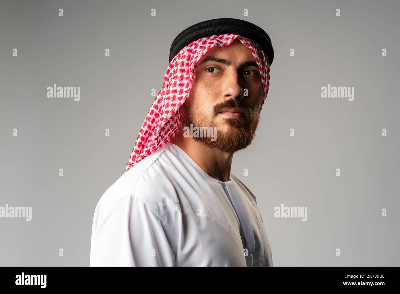 Portrait of young Arab man on gray background in studio Stock Photo - Alamy