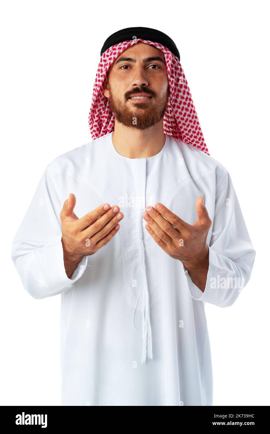 Young Arab man in traditional clothing praying on white background ...