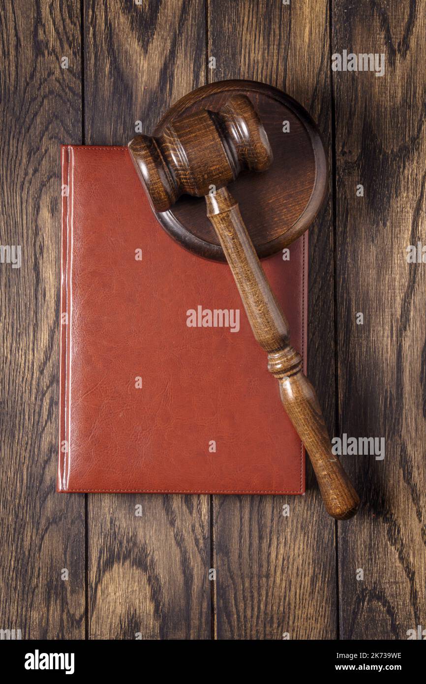 Wooden gavel and red law book on table top view Stock Photo - Alamy