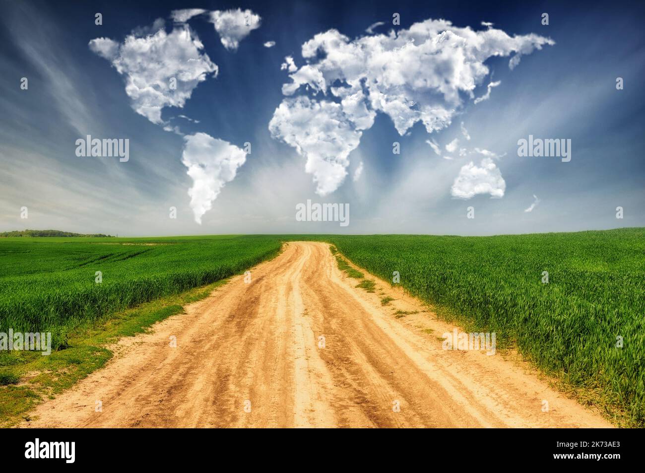 clouds in the form of a map of the world over a hilly field. road in a ...