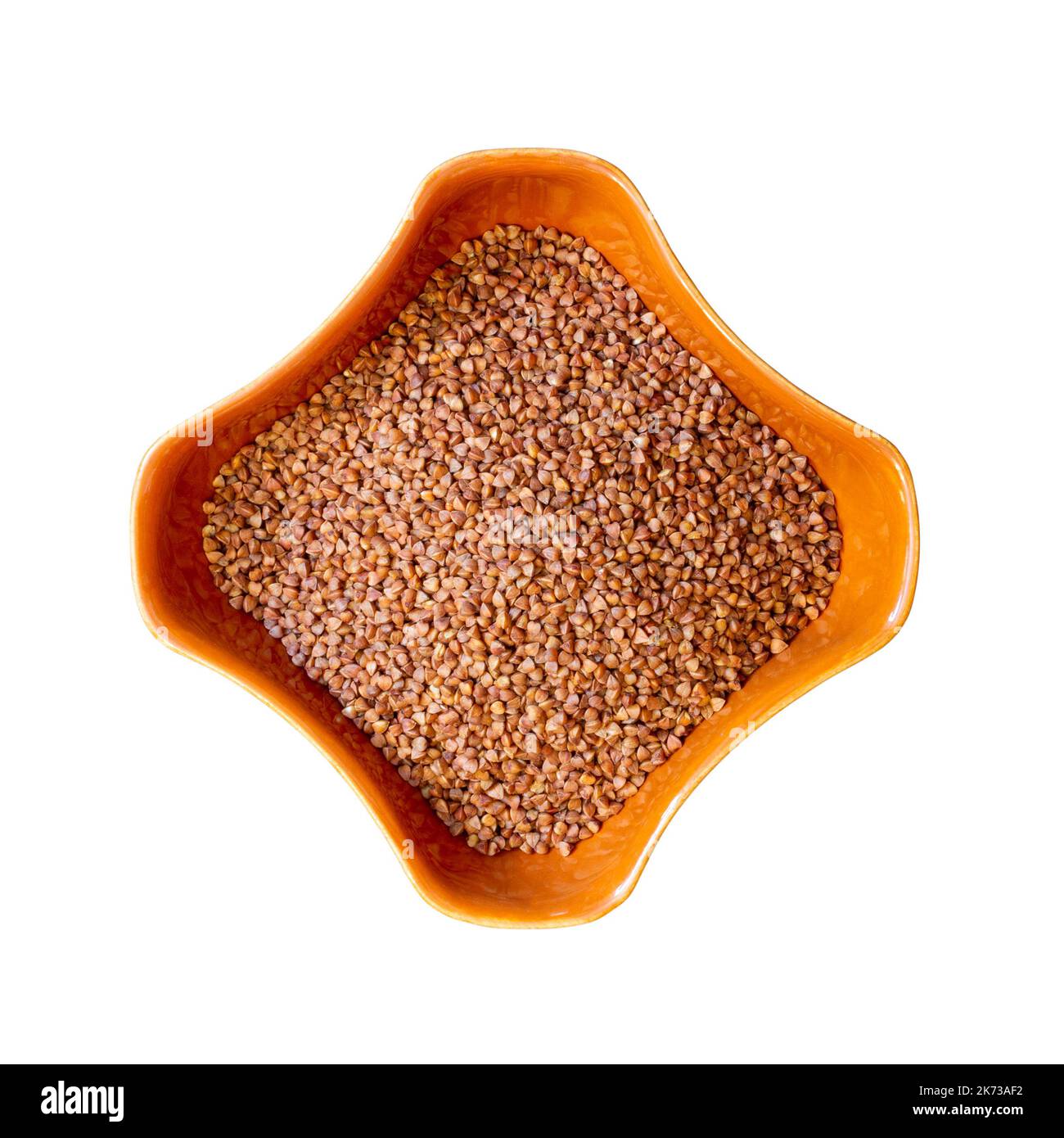 buckwheat in a brown bowl isolated on a white background close up with ...
