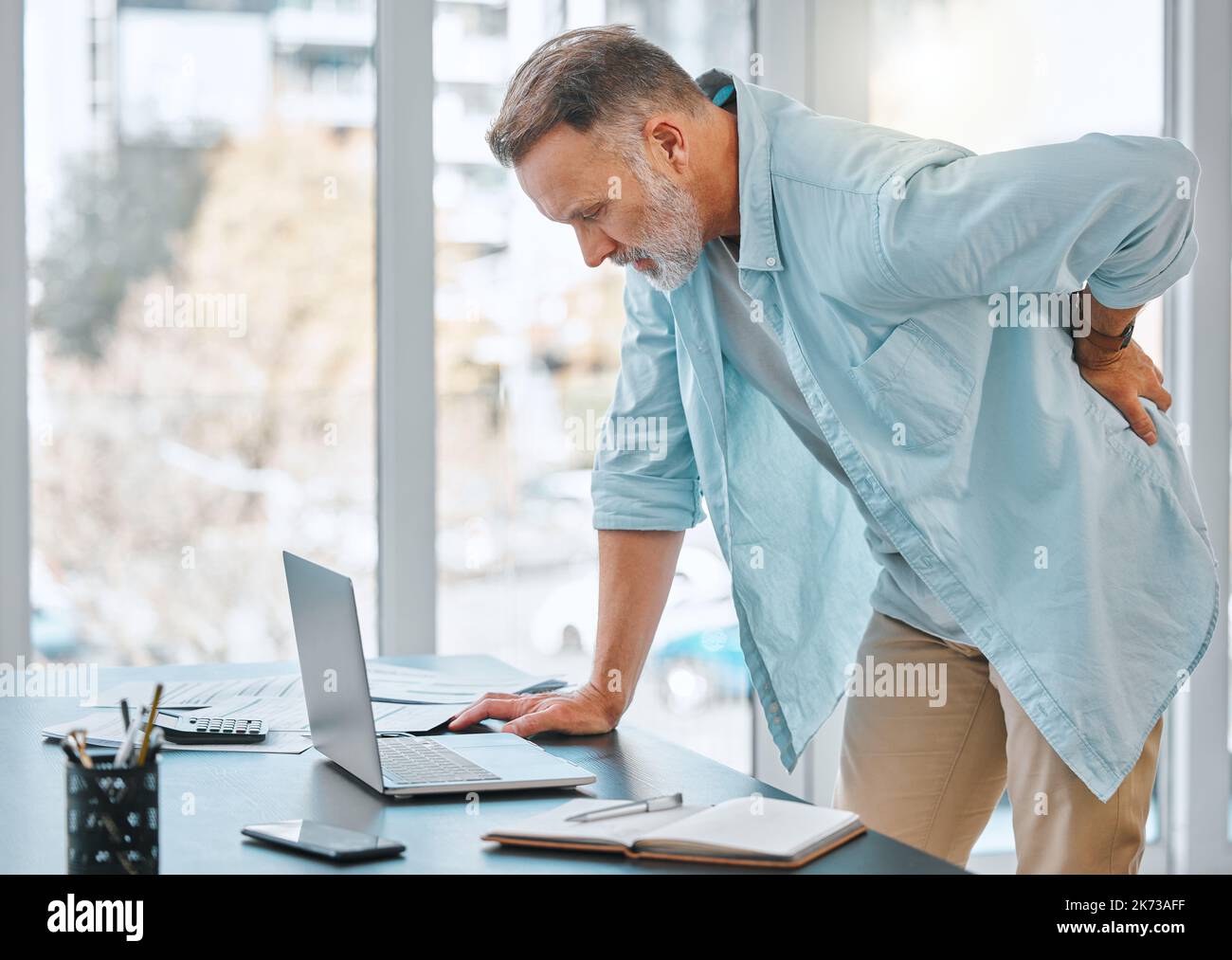 Its time to invest in a proper chair. a mature businessman standing ...