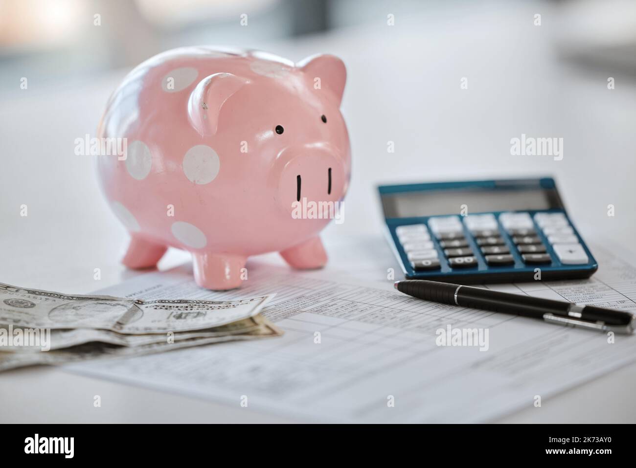 Too many people spend money they earned. a piggy bank on top of a ...