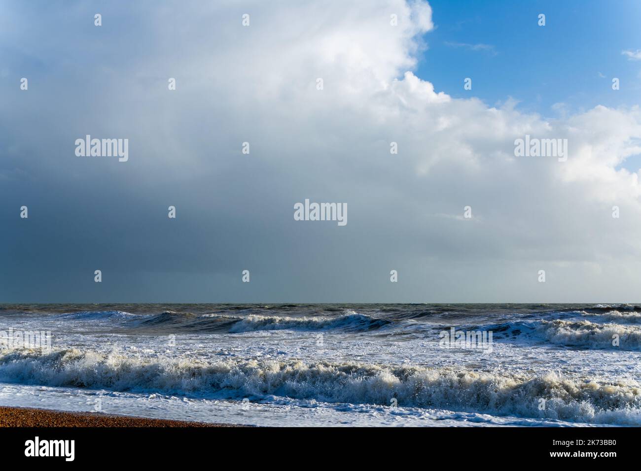 Waves breaking on Bexhill beach in late afternoon sun in November Stock ...
