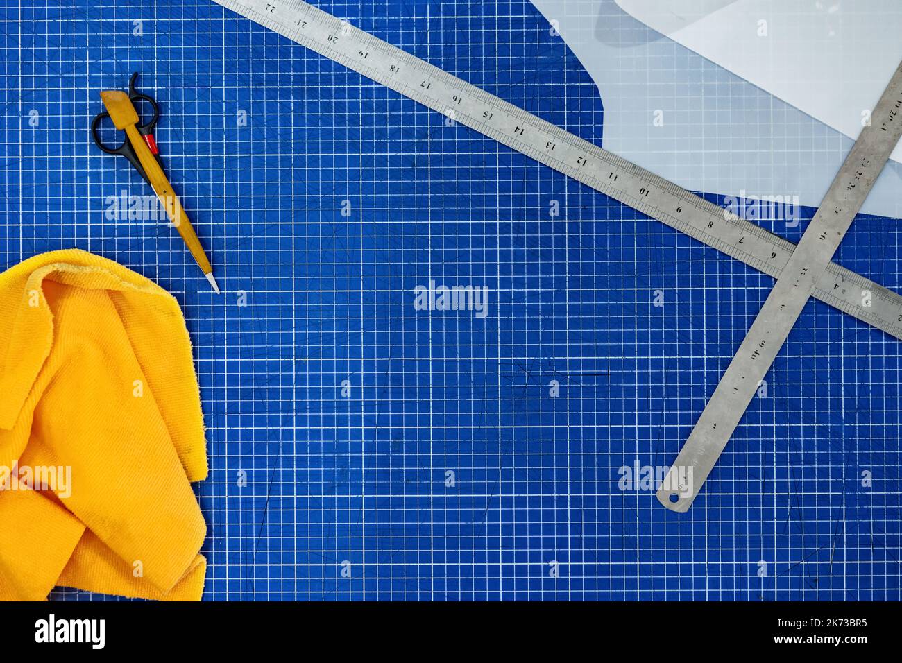 Desktop top view with blue cutting mat Stock Photo - Alamy