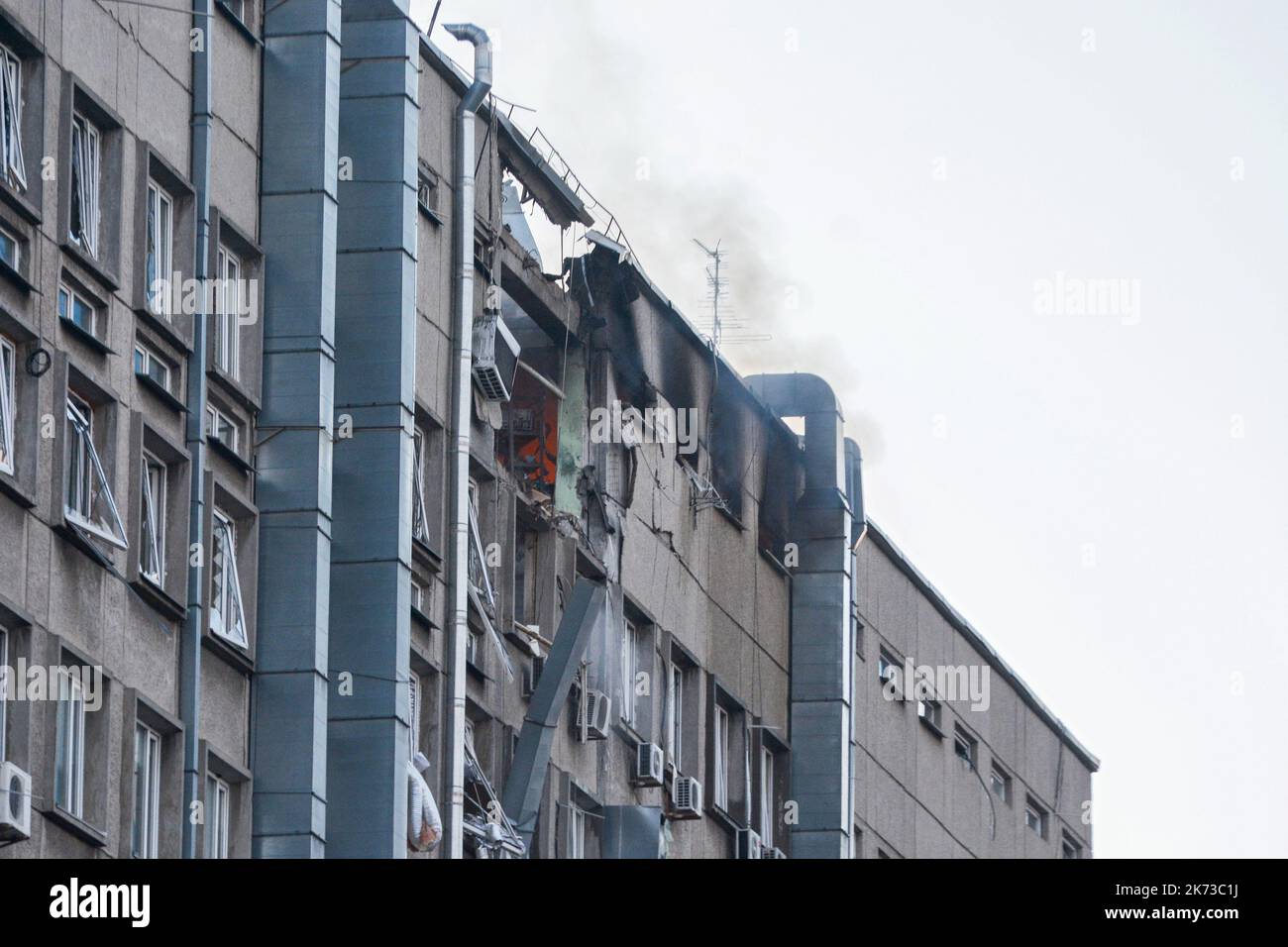 Kyiv, Ukraine. 17th Oct, 2022. Smoke rises from a building hit by ...