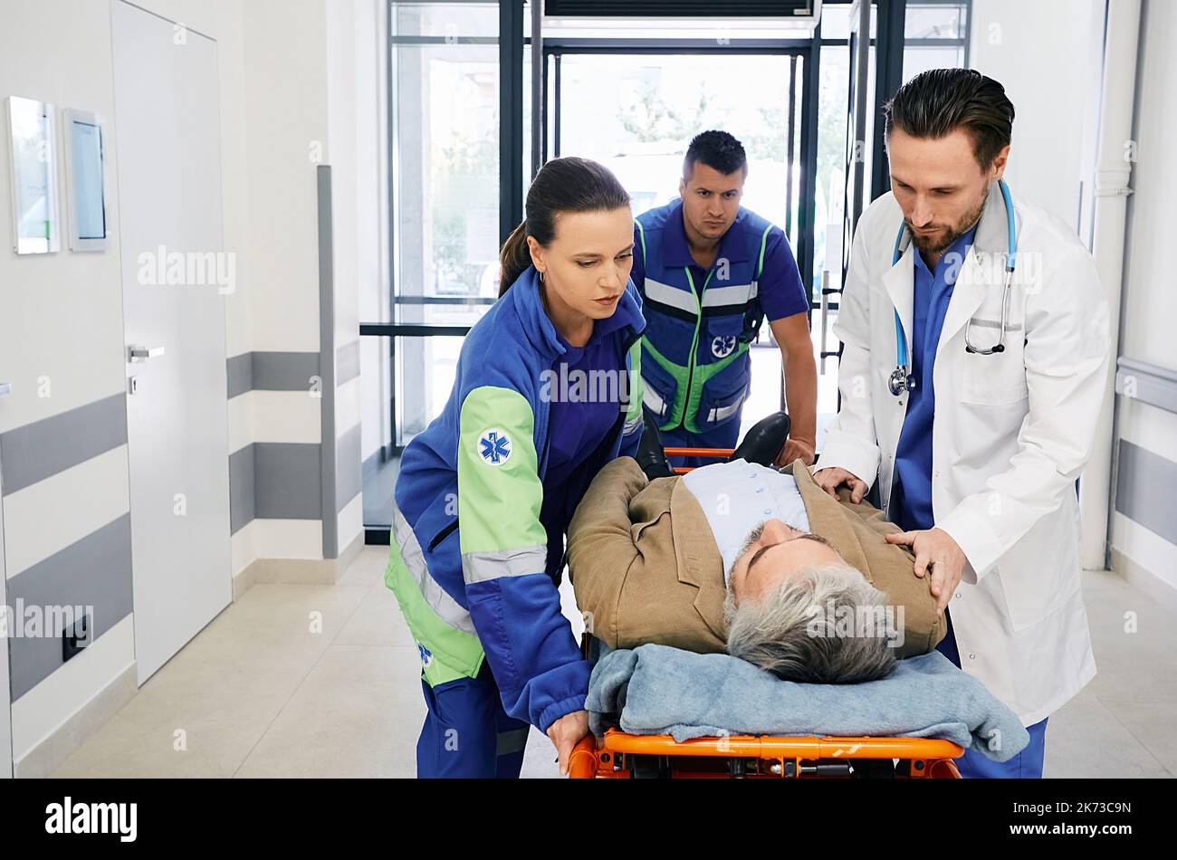 Paramedics and doctor rushing with victim patient on ambulance ...