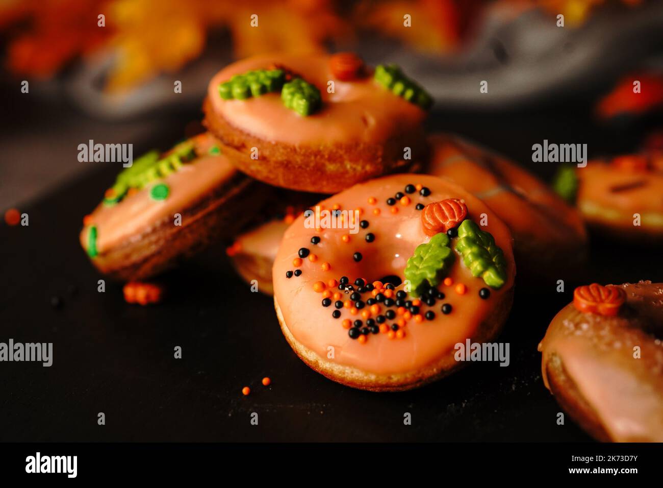 Homemade Mini autumn donuts with orange frosting, selective focu Stock ...