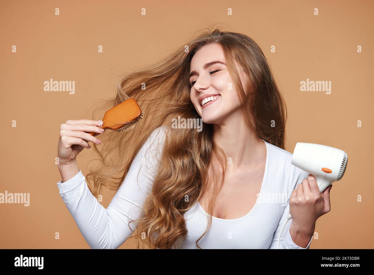 woman with strong healthy hair using hair dryer Stock Photo - Alamy