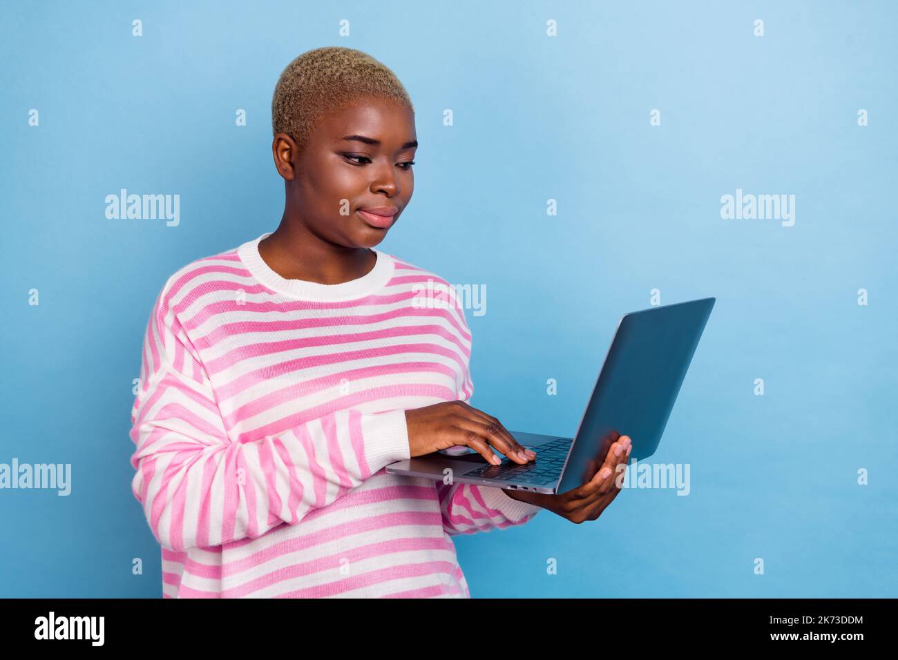 Photo of young attractive concentrated girl hold typing laptop search ...
