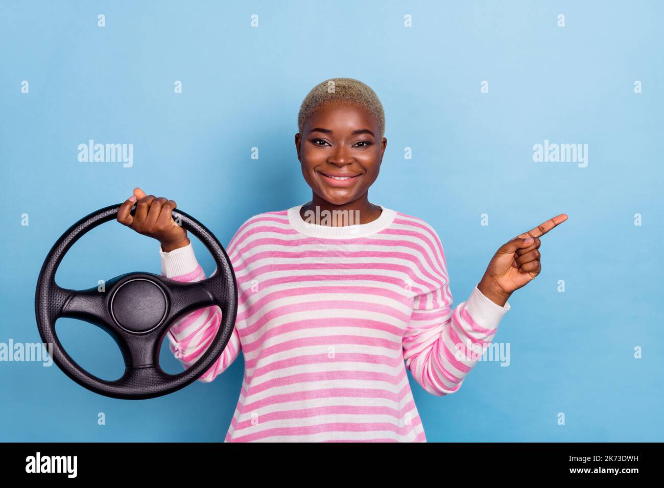 Portrait of attractive girl hands hold wheel point demonstrate copy ...
