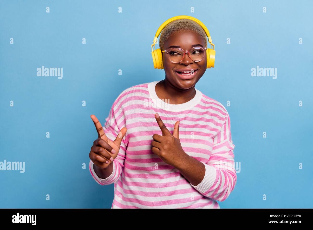 Photo of young excited smiling girl dancing directing fingers empty ...
