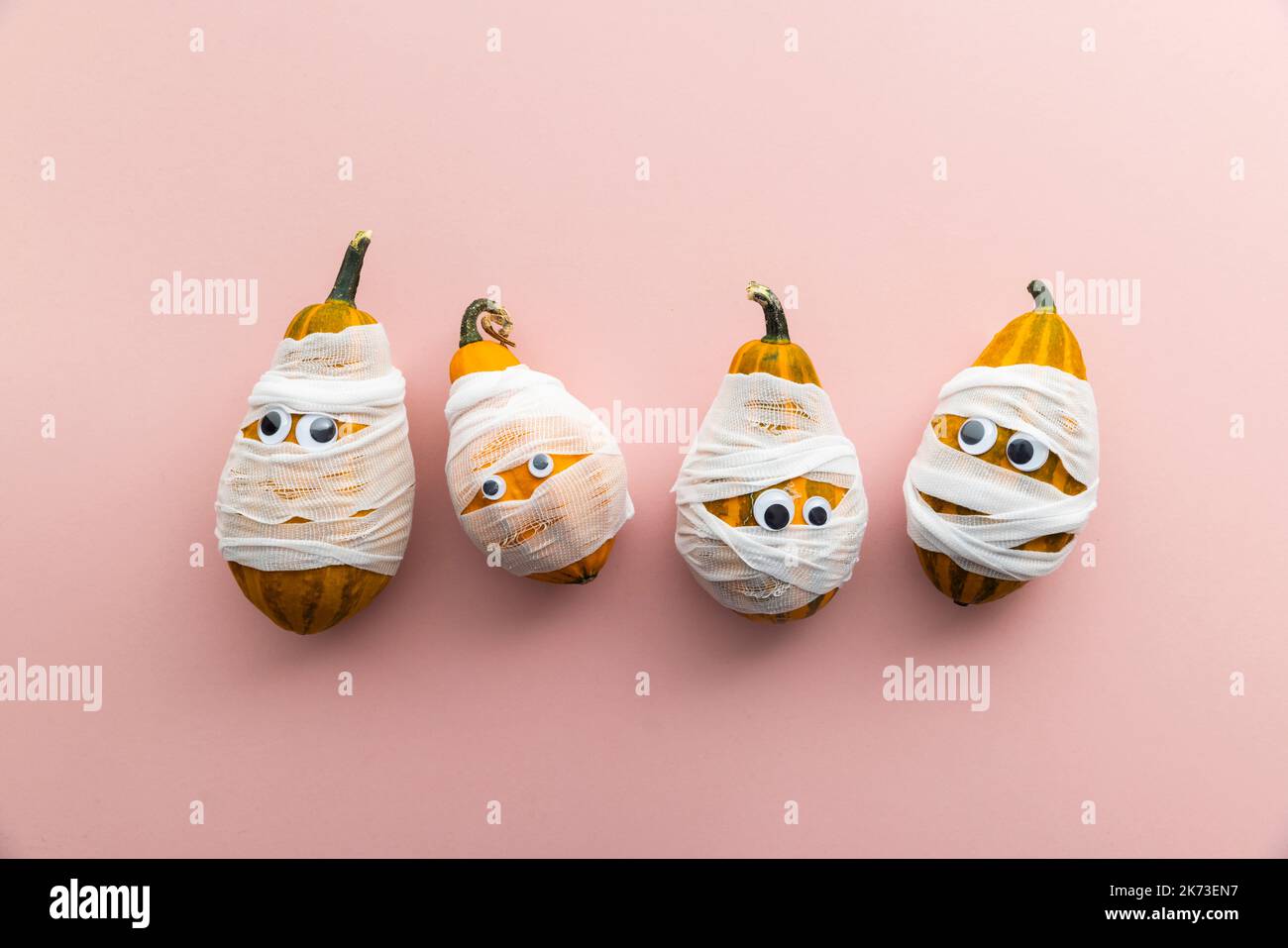 Hallowwen holiday background concept. Gourd pumpkins dressed as scary ...