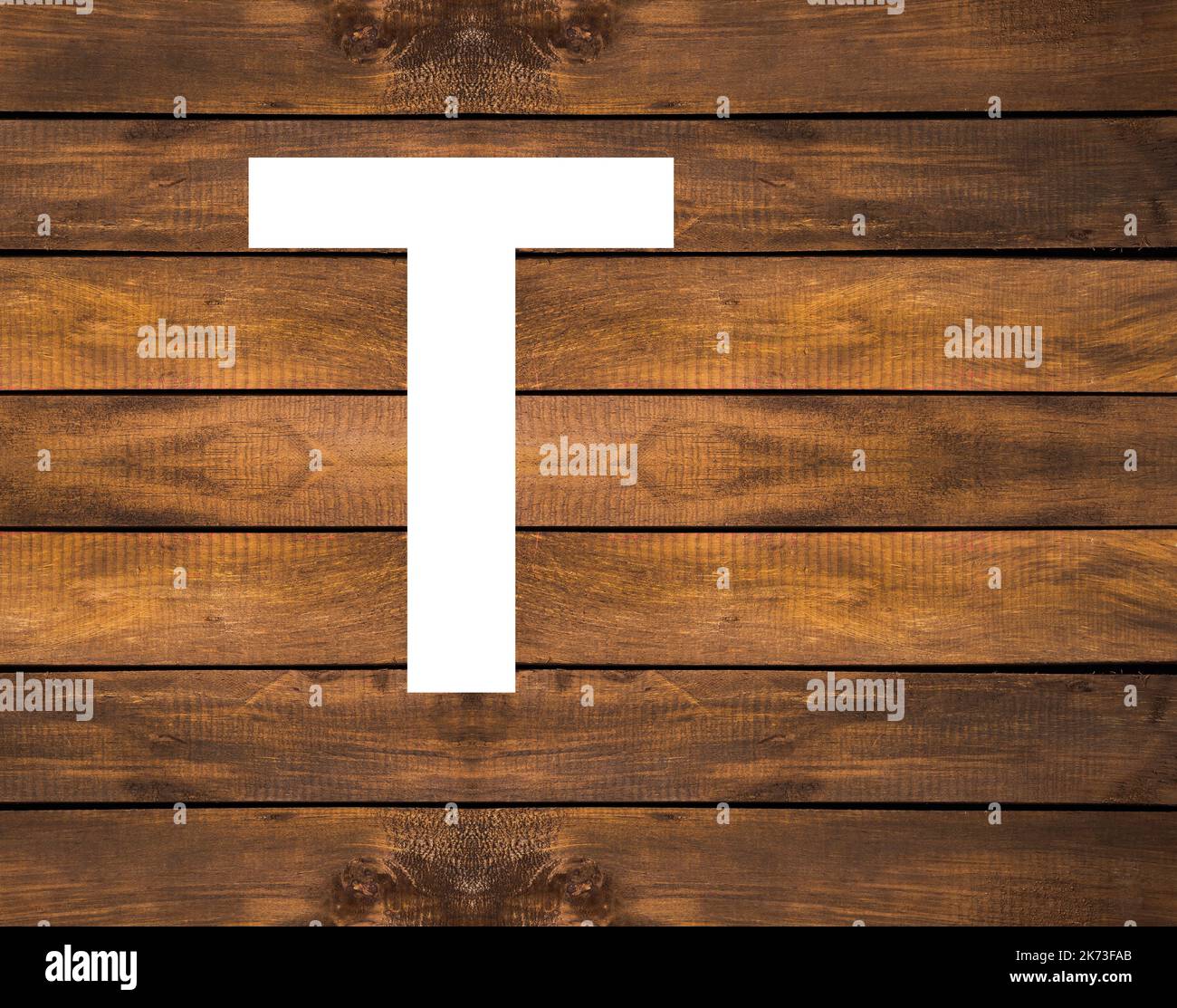 Alphabet letter T in white hole on wood background Stock Photo - Alamy