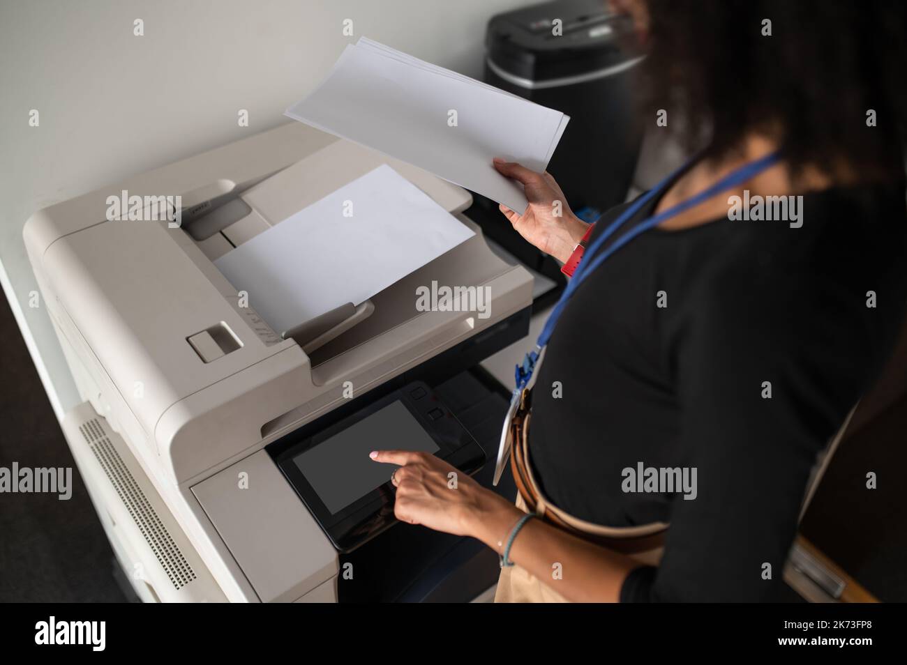 Woman standing near the xerox in the office Stock Photo - Alamy