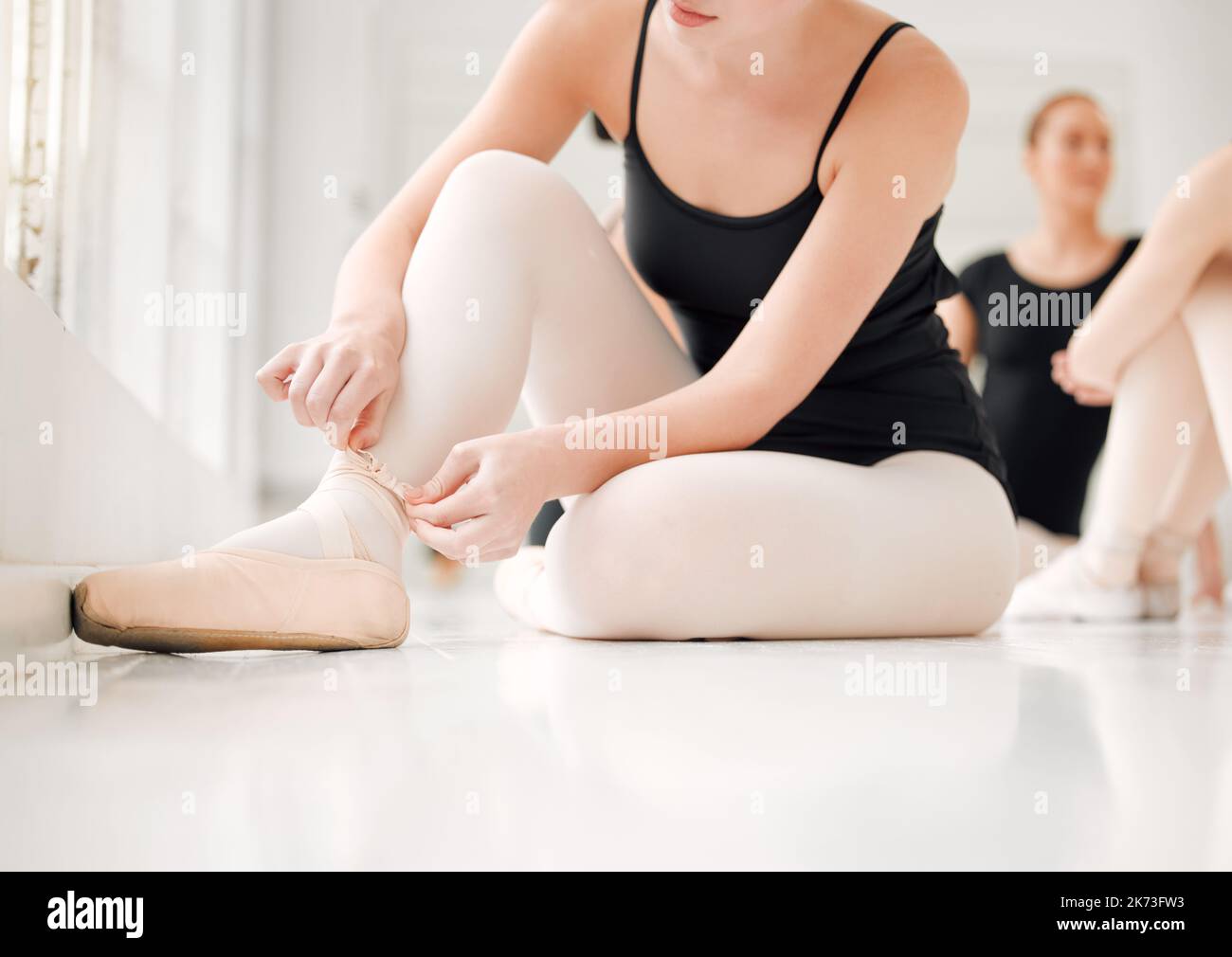 Like no ones watching you. an unrecognizable ballet dancer tying on her pointe shoes Stock Photo ...