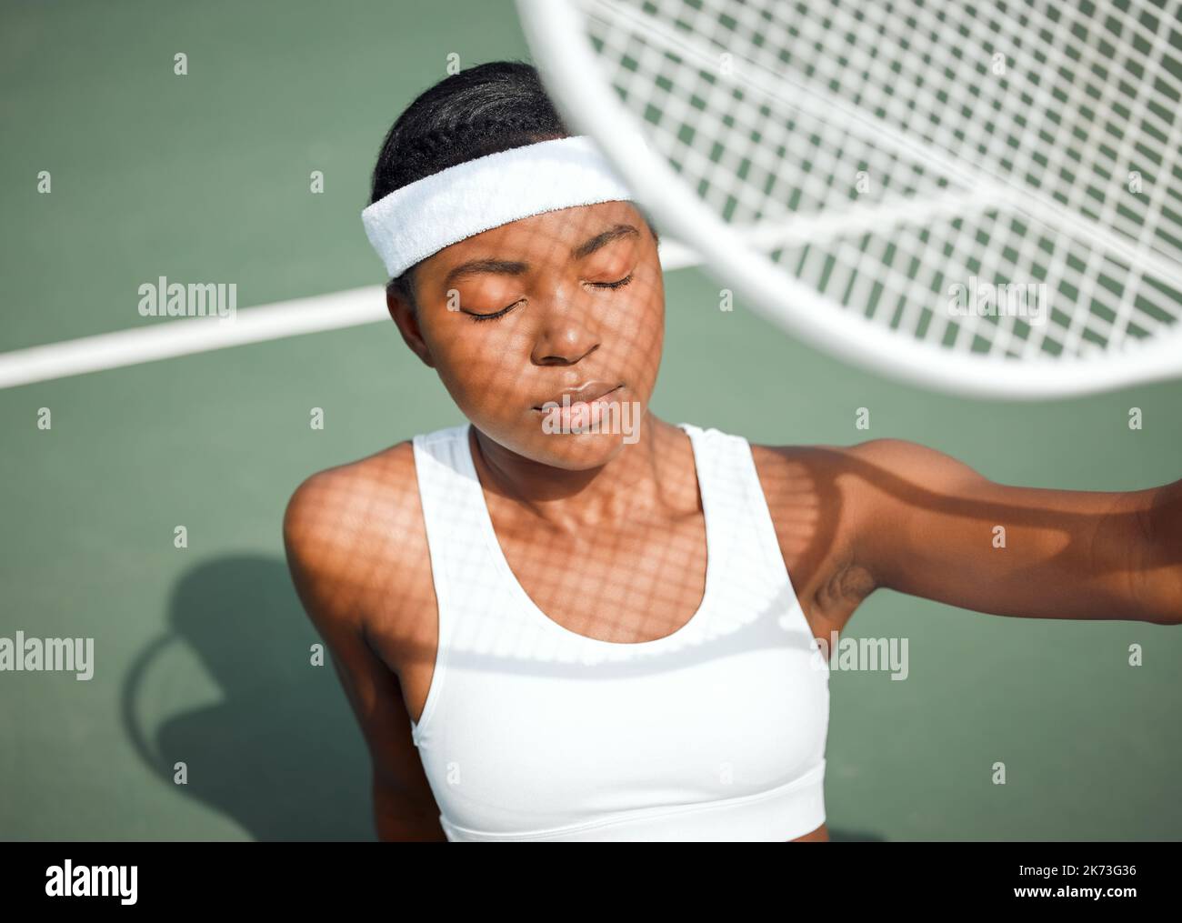 She glows differently. a sporty young woman shielding her face from the ...