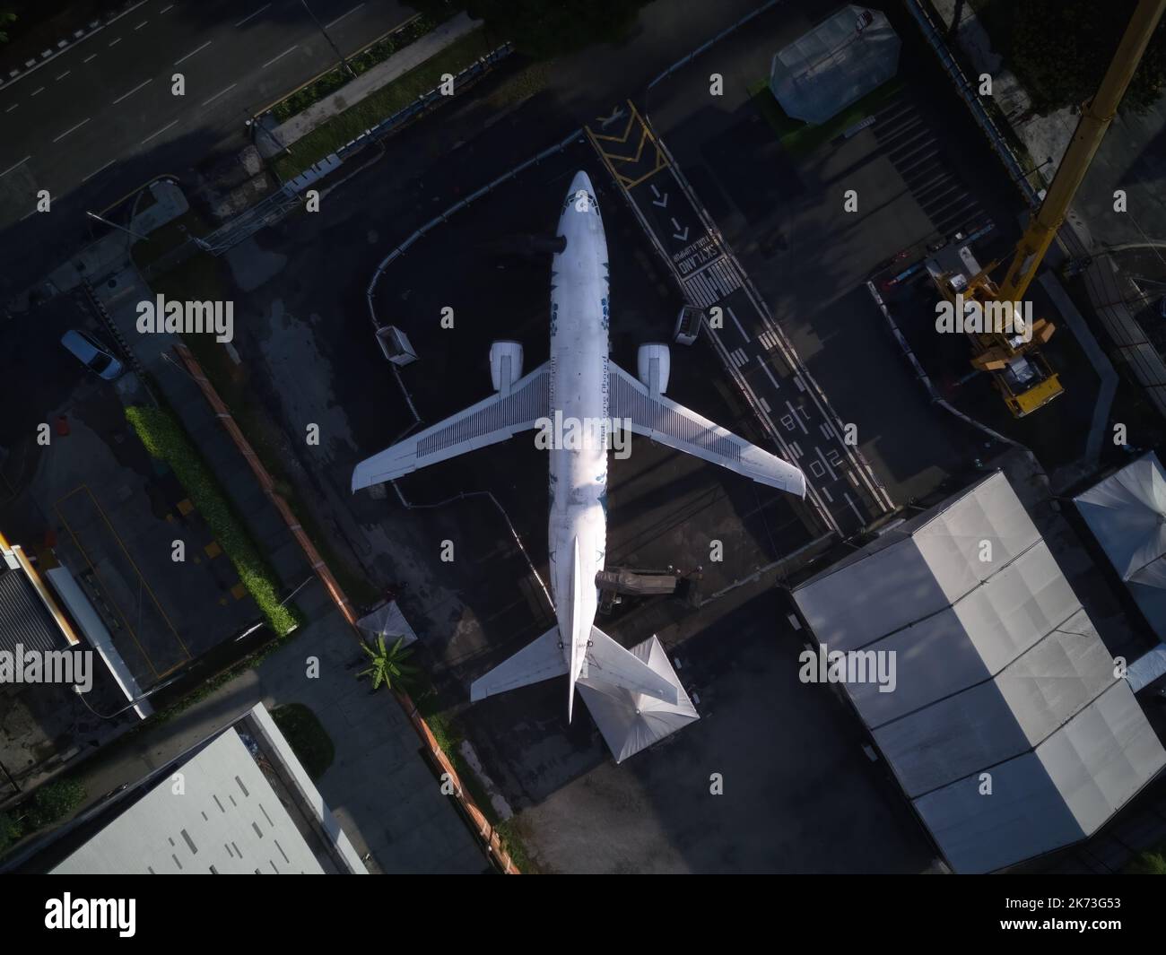 Overhead shot of plane in the city with crane beside it Stock Photo - Alamy
