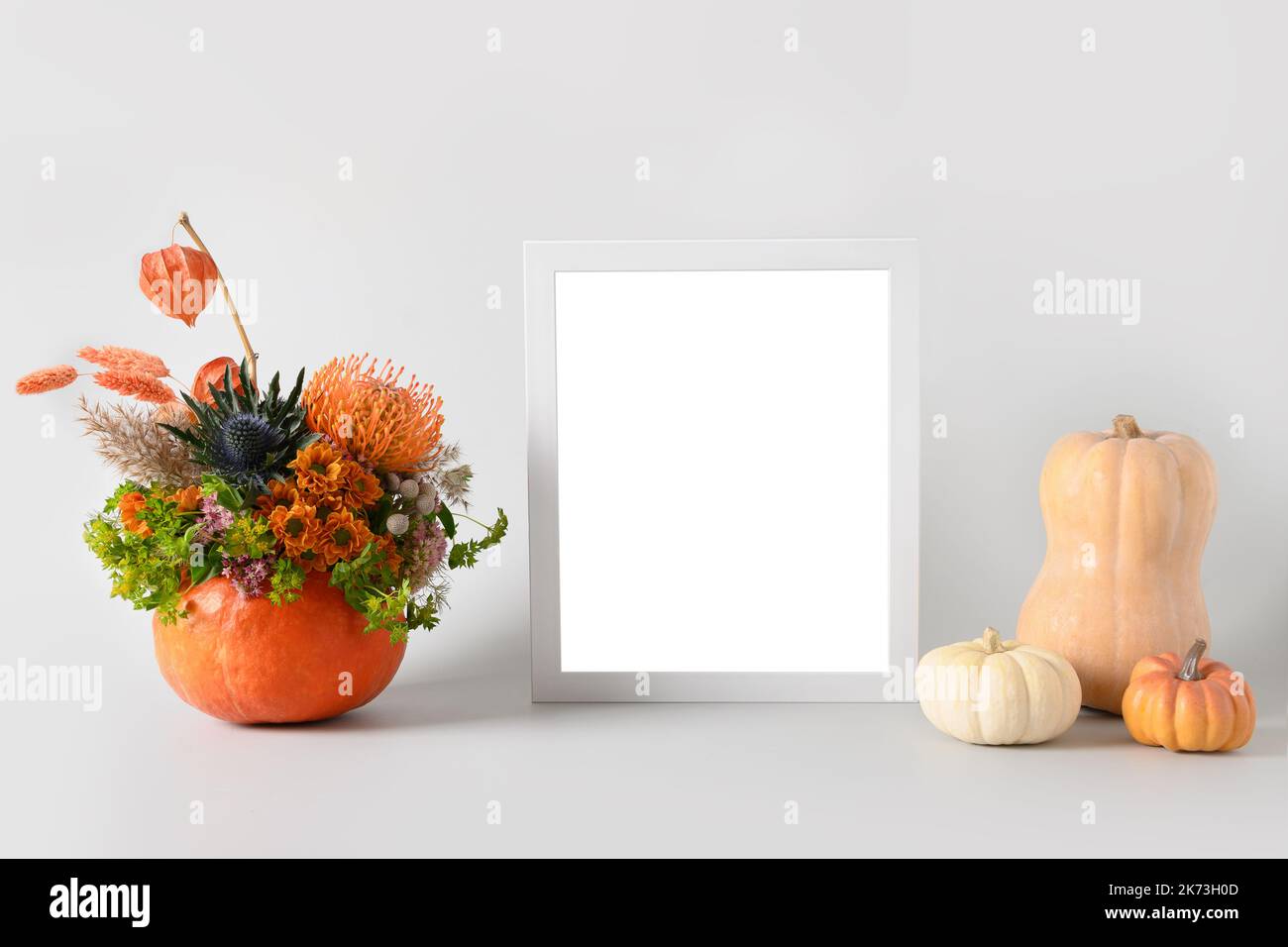 Autumn mockup with flowers bouquet in pumpkin, decor elements and white ...