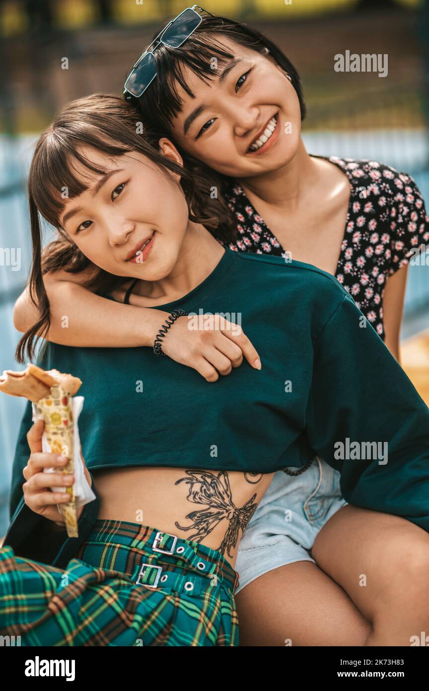 Pretty girls hugging each other and looking happy Stock Photo - Alamy