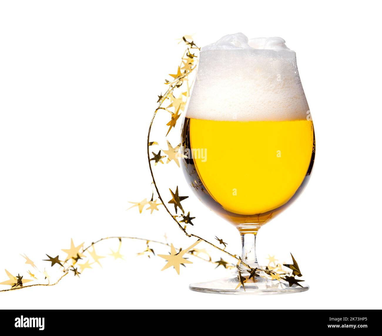 Full snifter glass of lager of pilsner beer with christmas tinsel ...