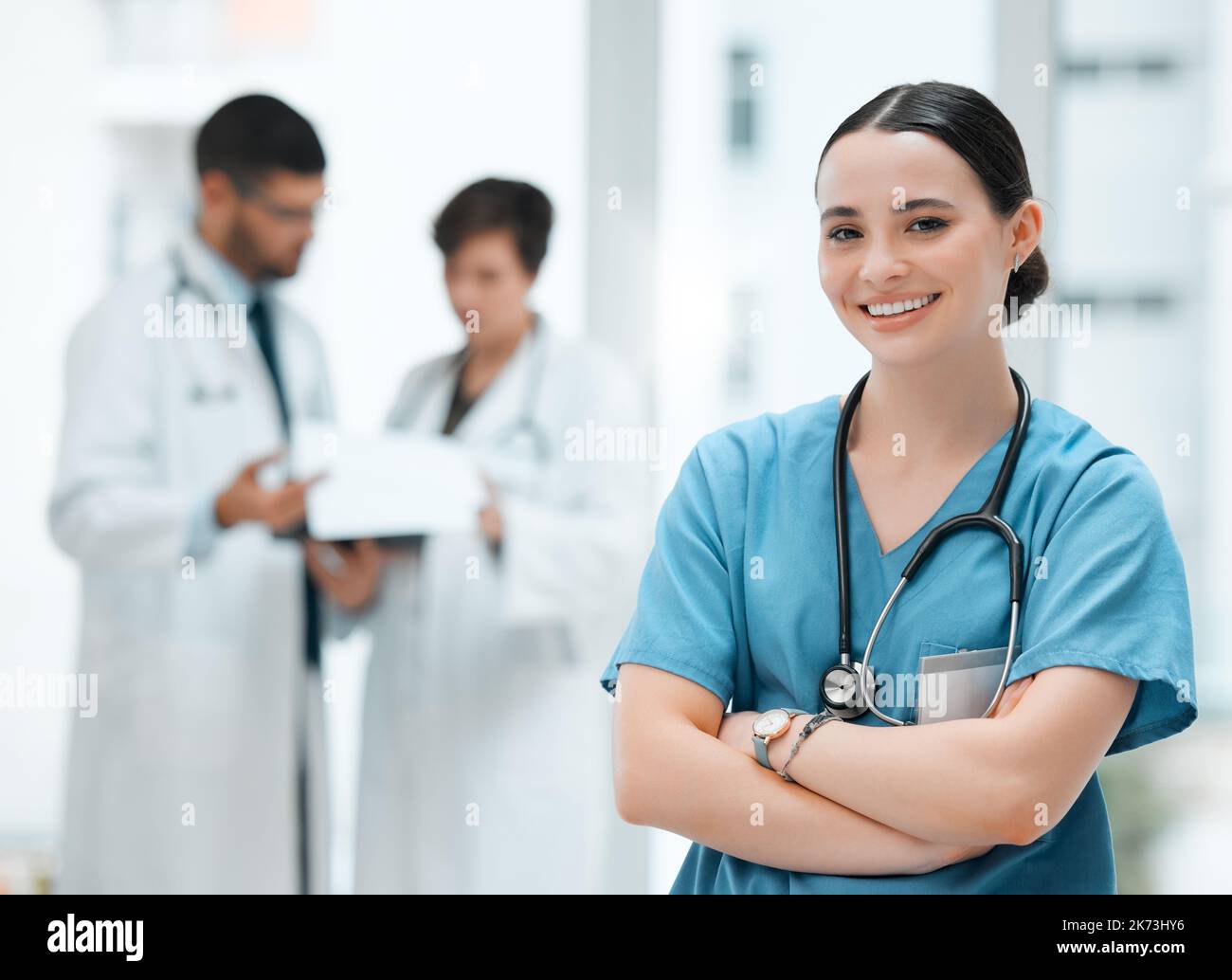 Always ready for patients. a young female doctor standing with her arms ...