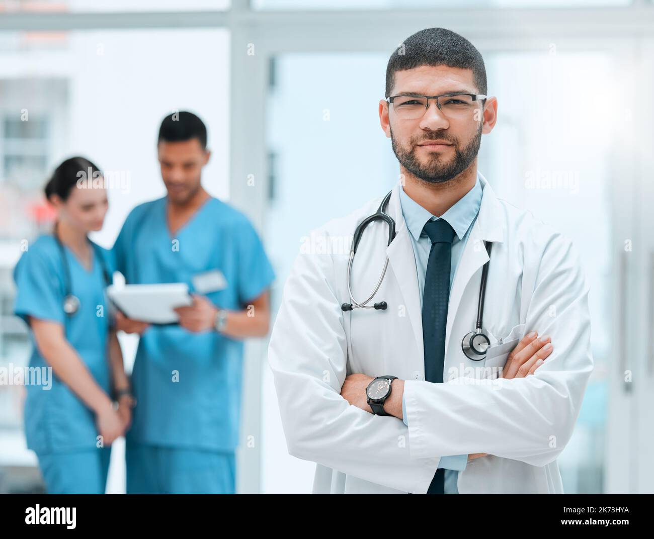 Healthcare is the name of my game. a young male doctor standing with ...