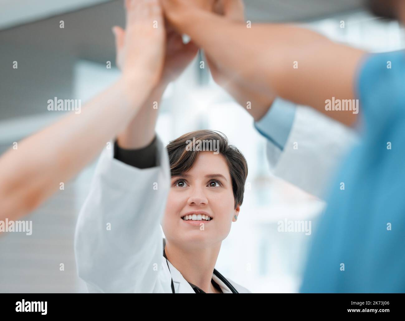 Lets tackle this day. a group of doctors giving each other a high five ...