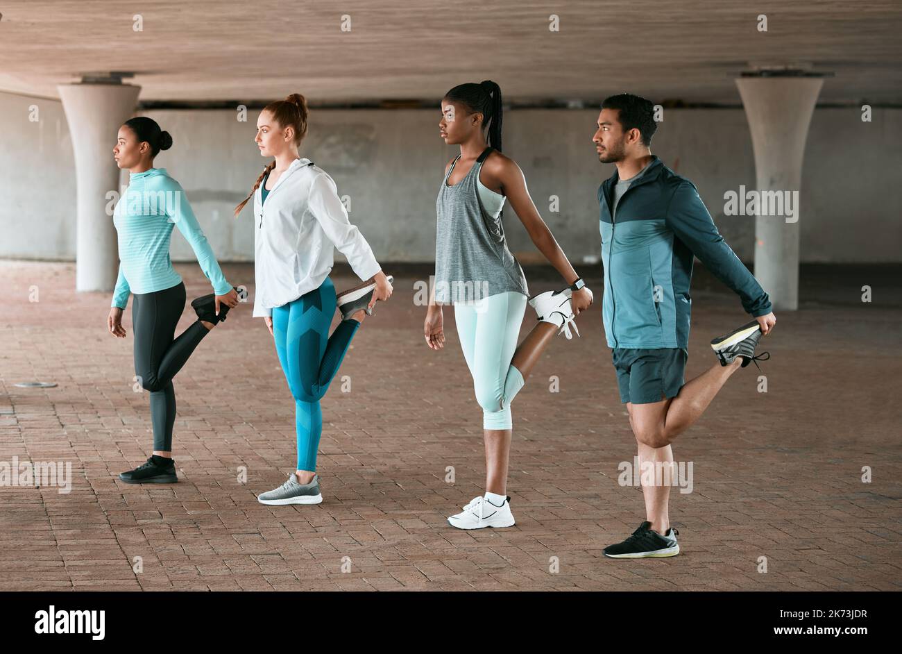 Good health starts from within. a group of friends stretching before a ...