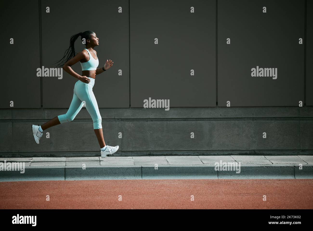 I feel the dopamine surging. a young woman running outside Stock Photo ...