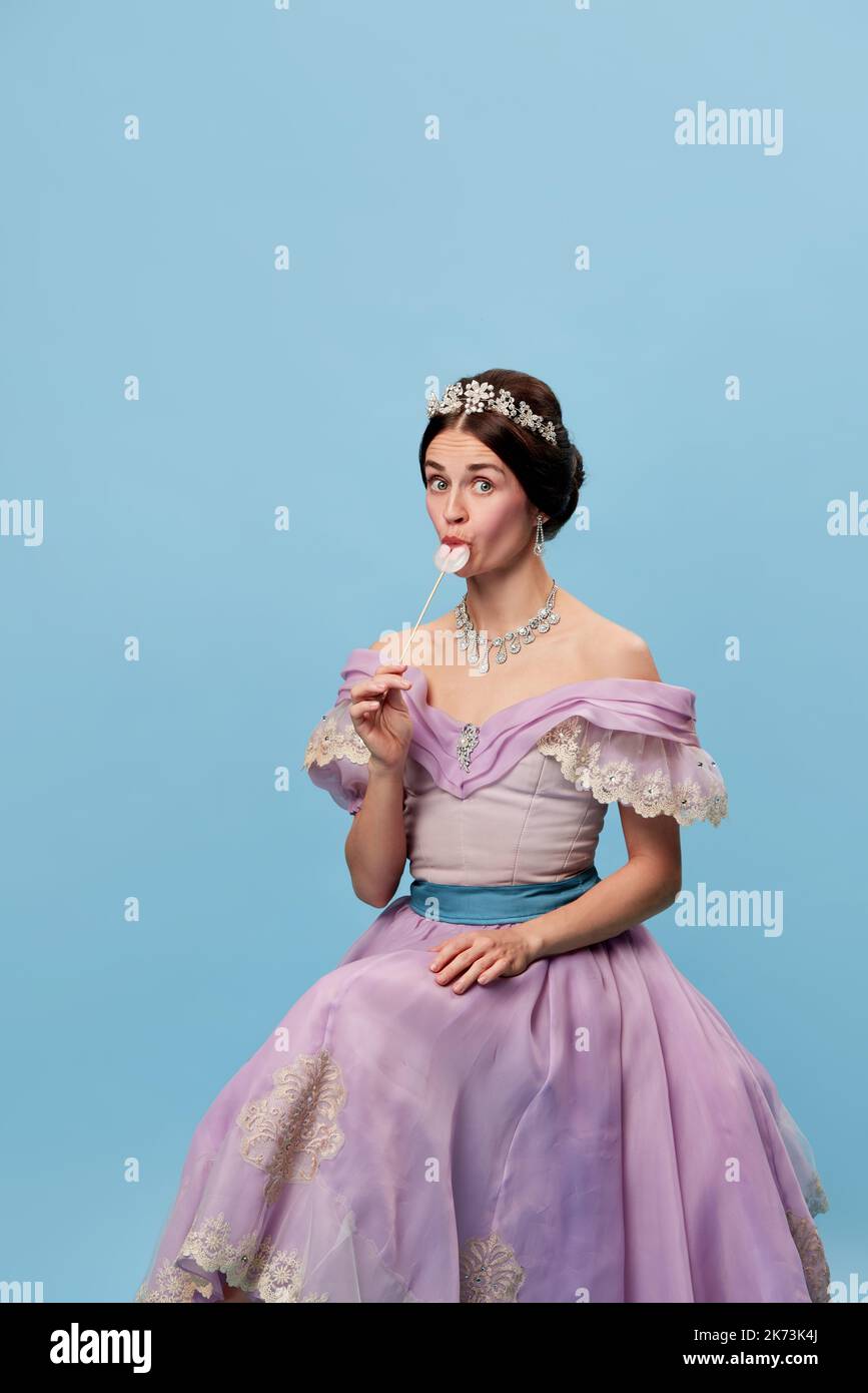 Flirt. Portrait of sensual young girl in lilac color medieval dress as ...