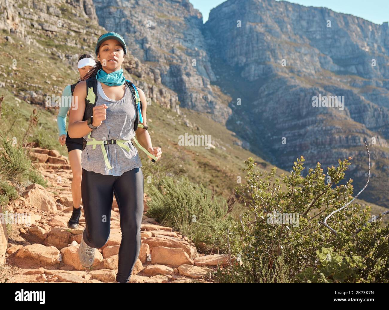 Put your heart into it. two young women running along a trail on the ...
