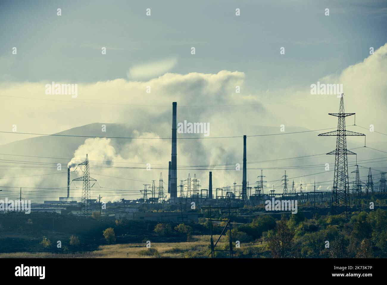 Industrial landscape with heavy pollution produced by a large factory ...